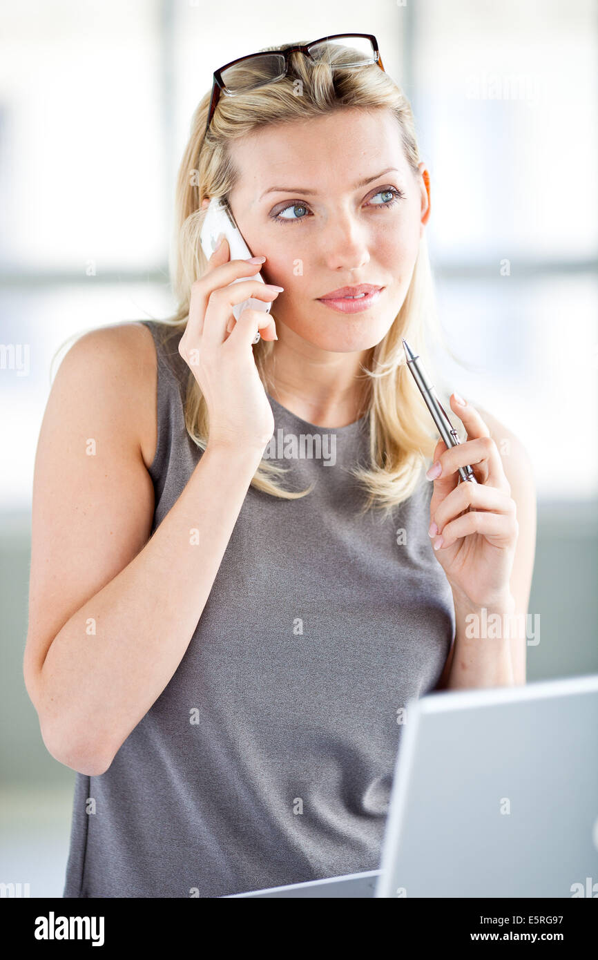 Woman using a cell phone Stock Photo - Alamy