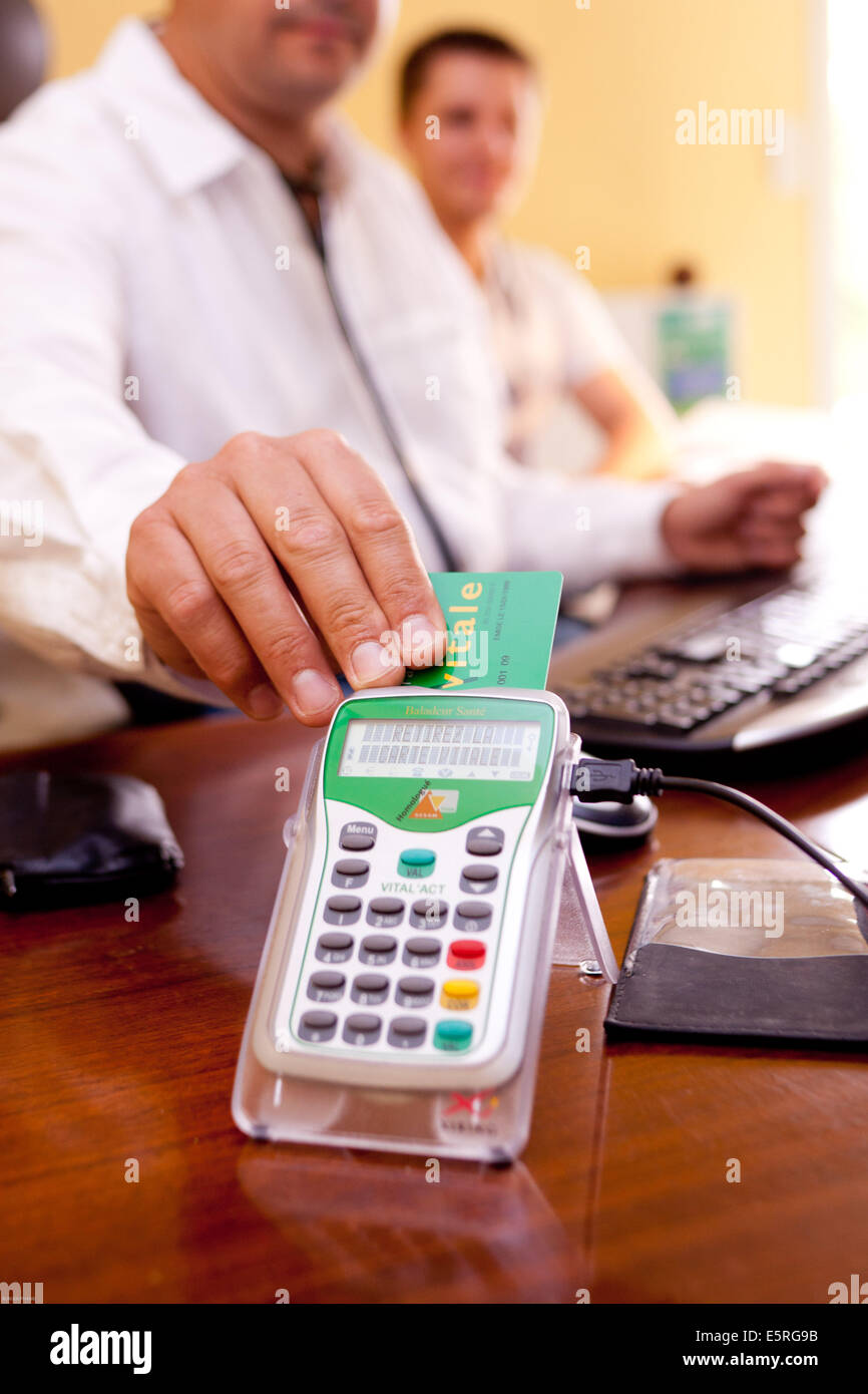 General practitioner using reading terminal for social insurance ...