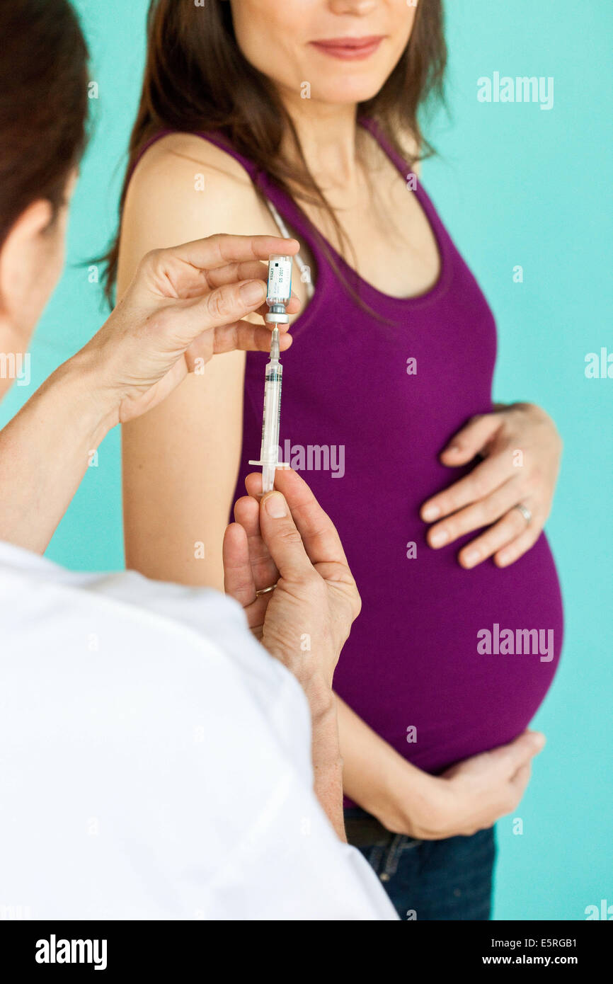Pregnant woman receiving vaccination Stock Photo - Alamy