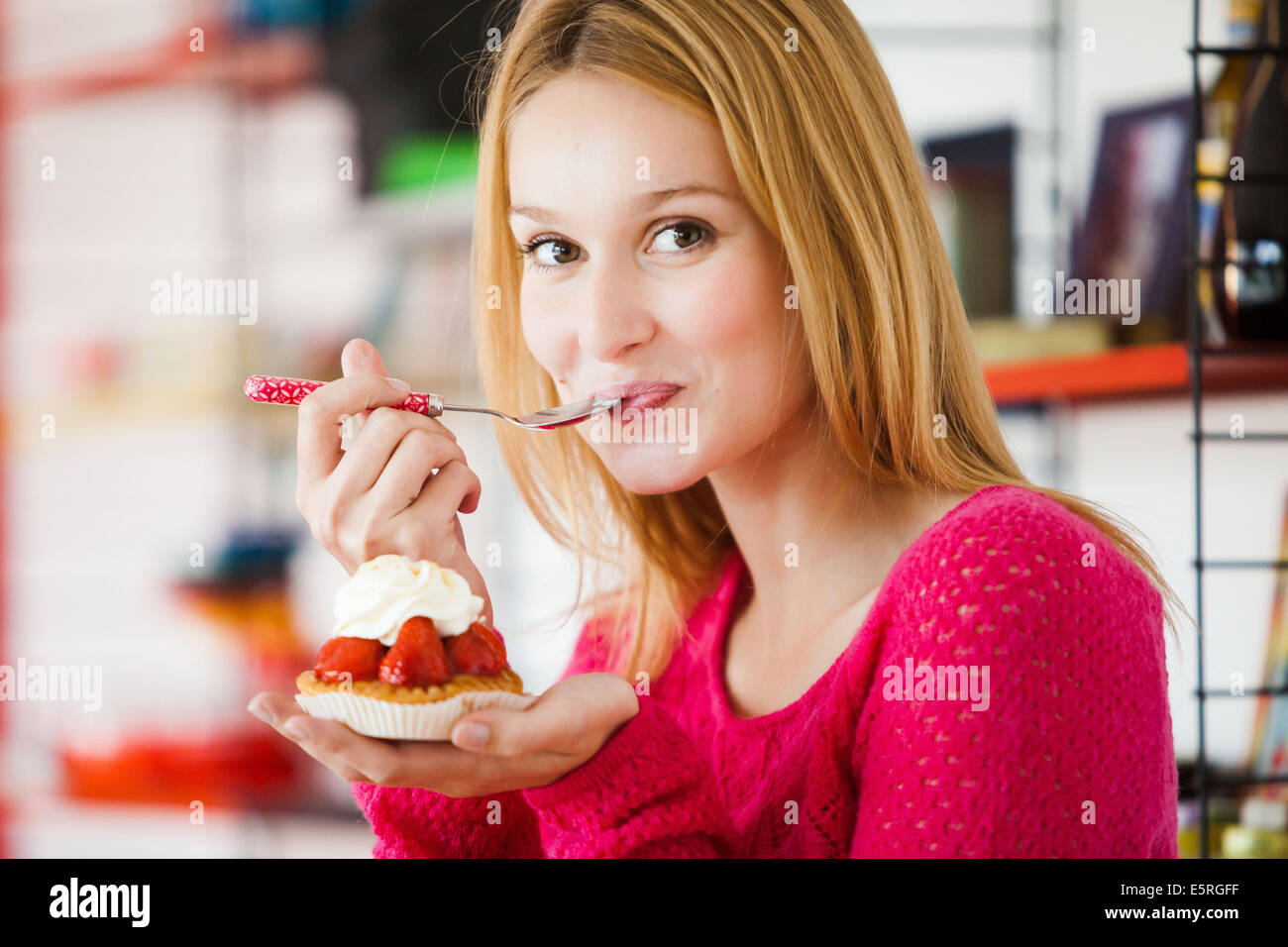 Woman eating pastry Stock Photo - Alamy