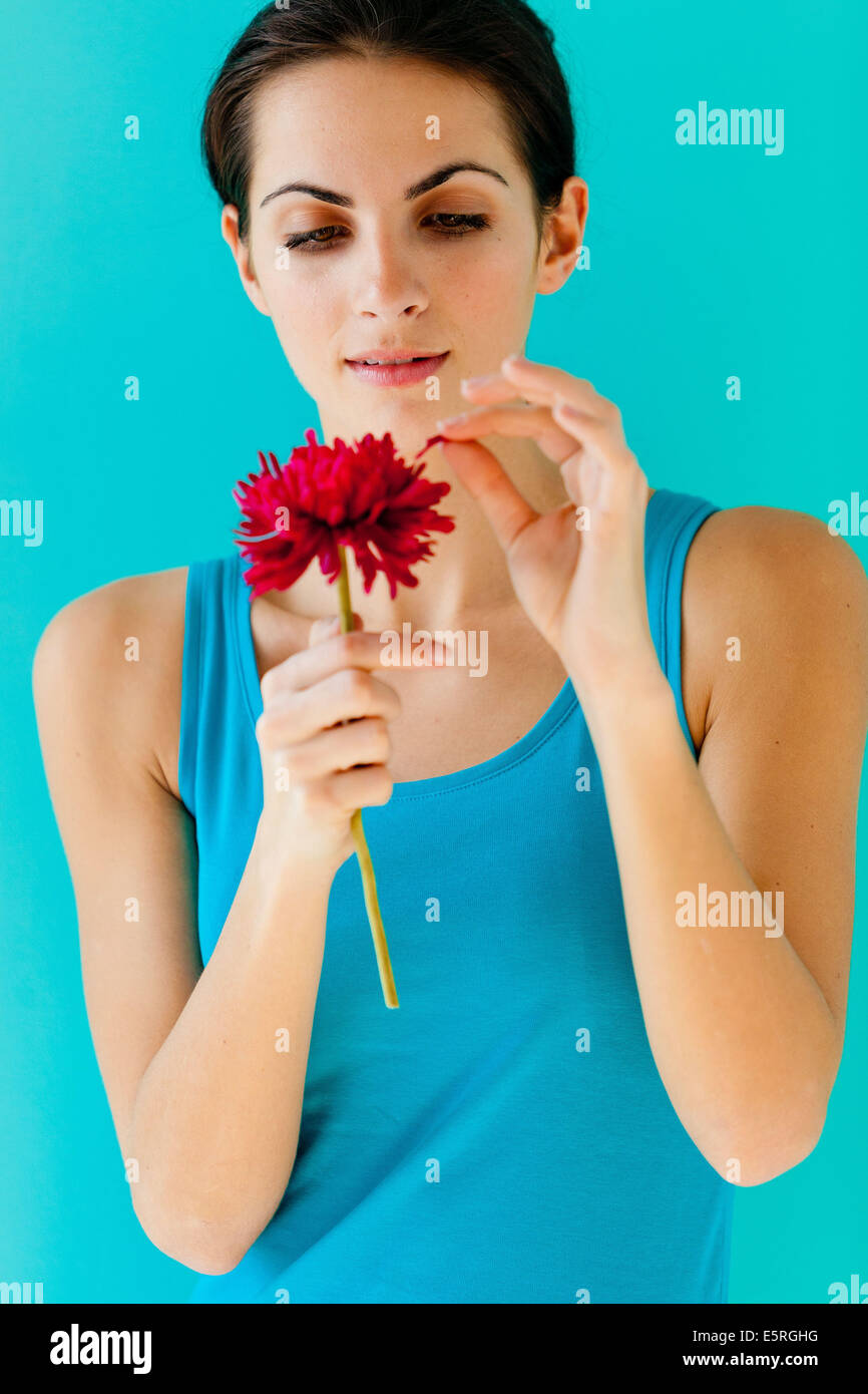 Woman plucking a flower Stock Photo - Alamy