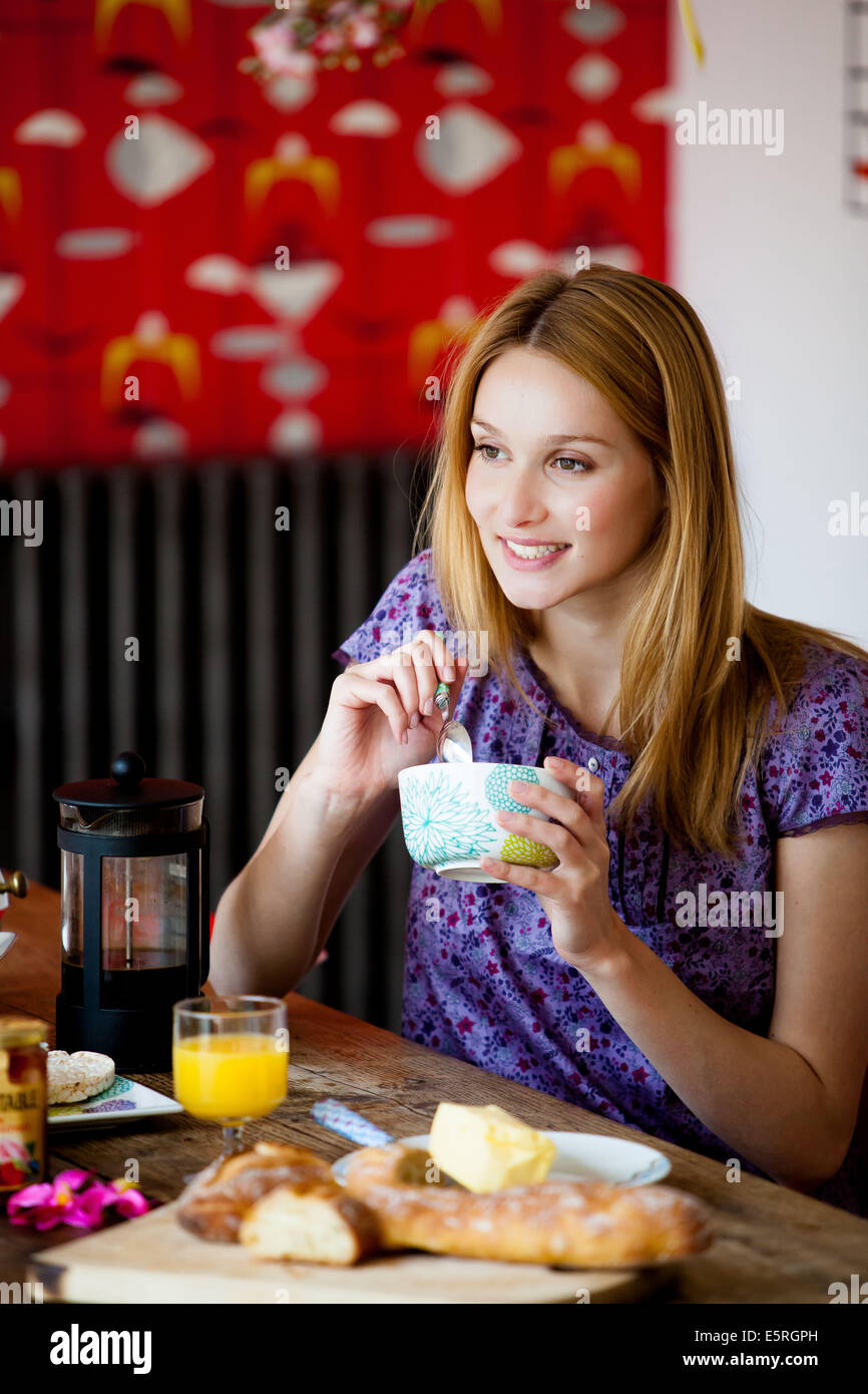 Woman having breakfast Stock Photo - Alamy