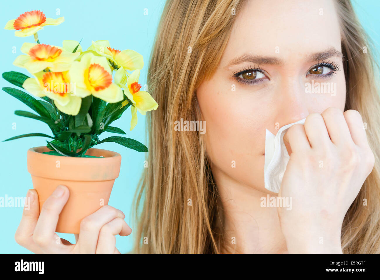 Woman sneezing into a handkerchief Stock Photo - Alamy