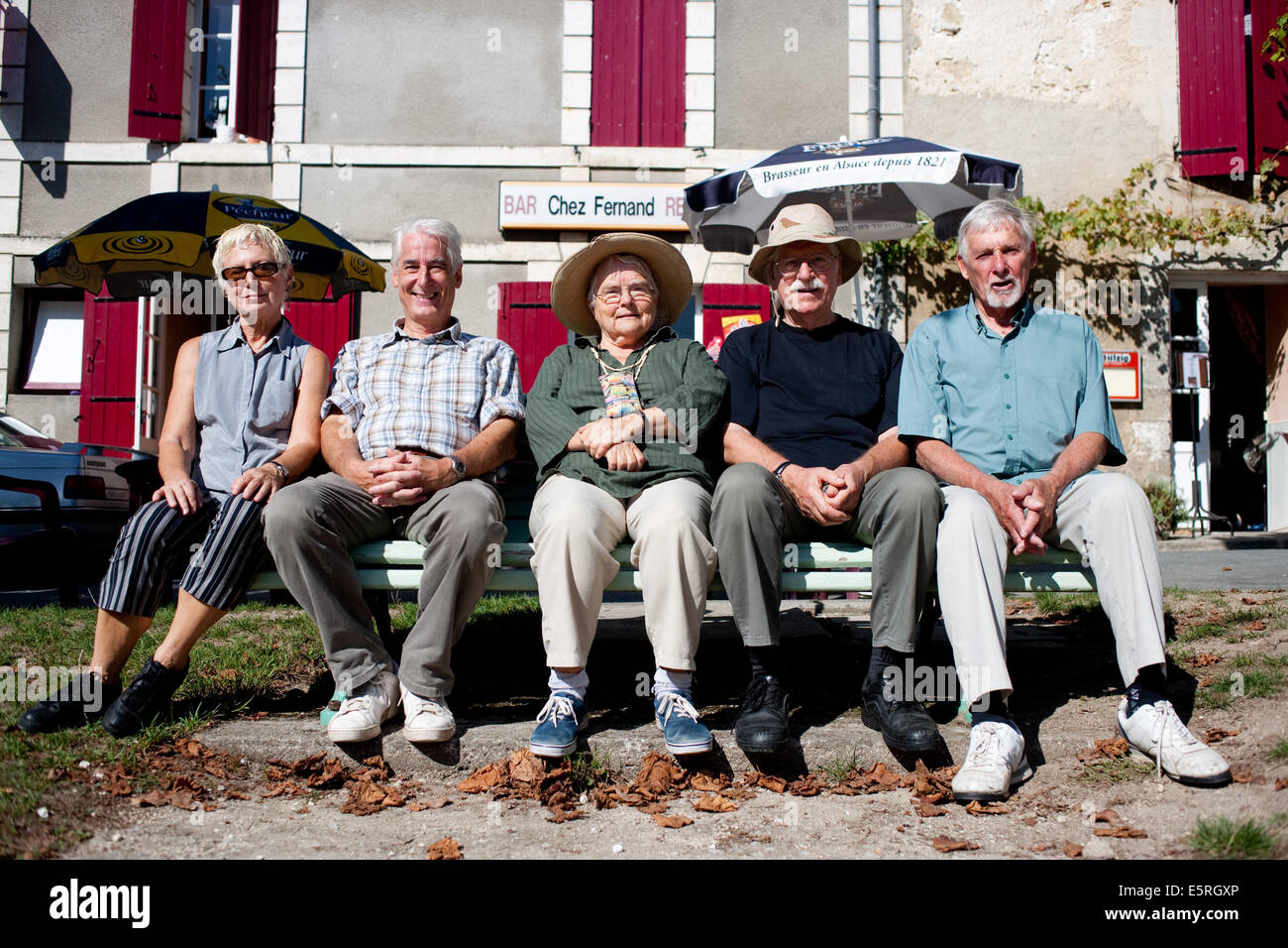 Group of seniors sitting on bench Stock Photo - Alamy