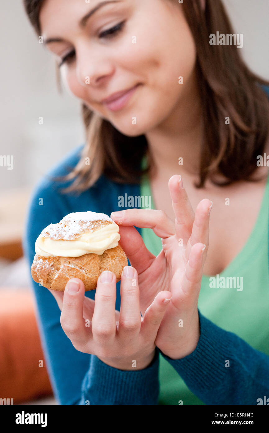 Woman eating pastry Stock Photo - Alamy