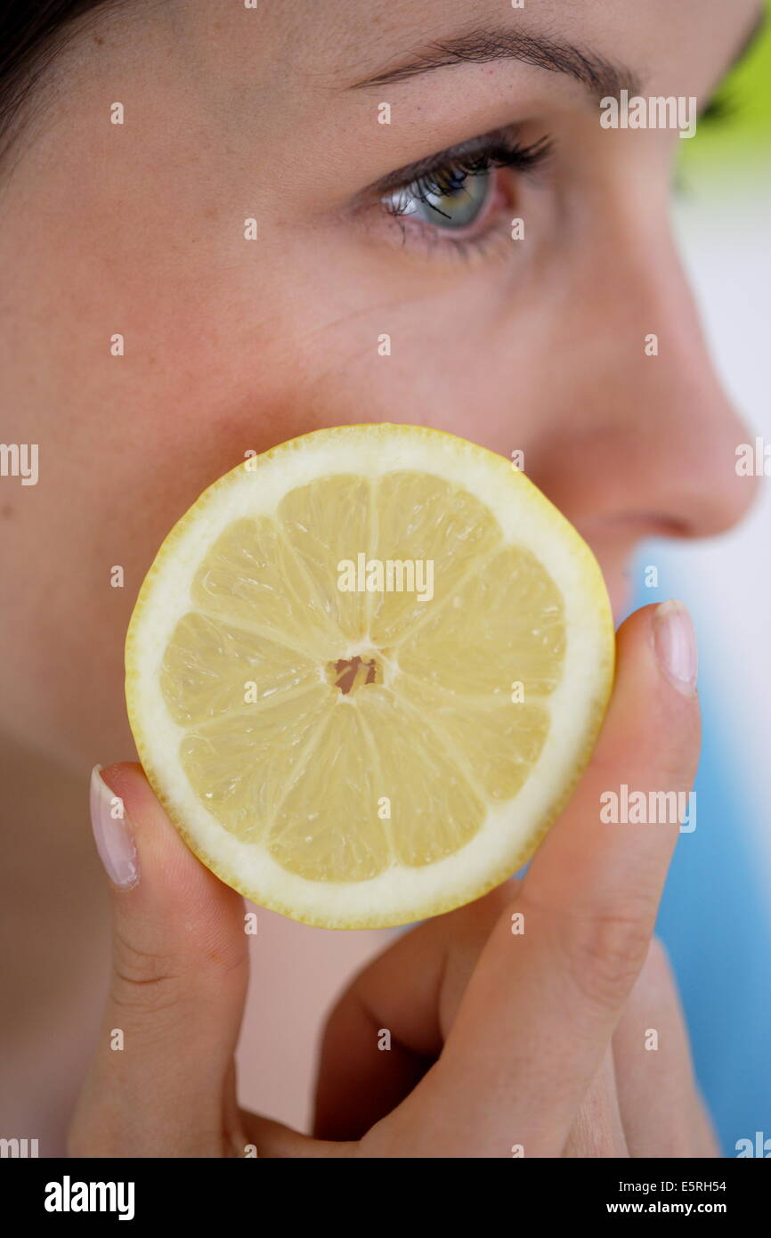 Woman with lemon slice Stock Photo - Alamy