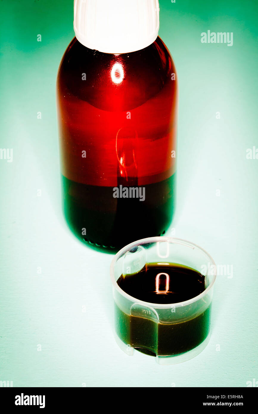 Syrup bottle and cup Stock Photo - Alamy