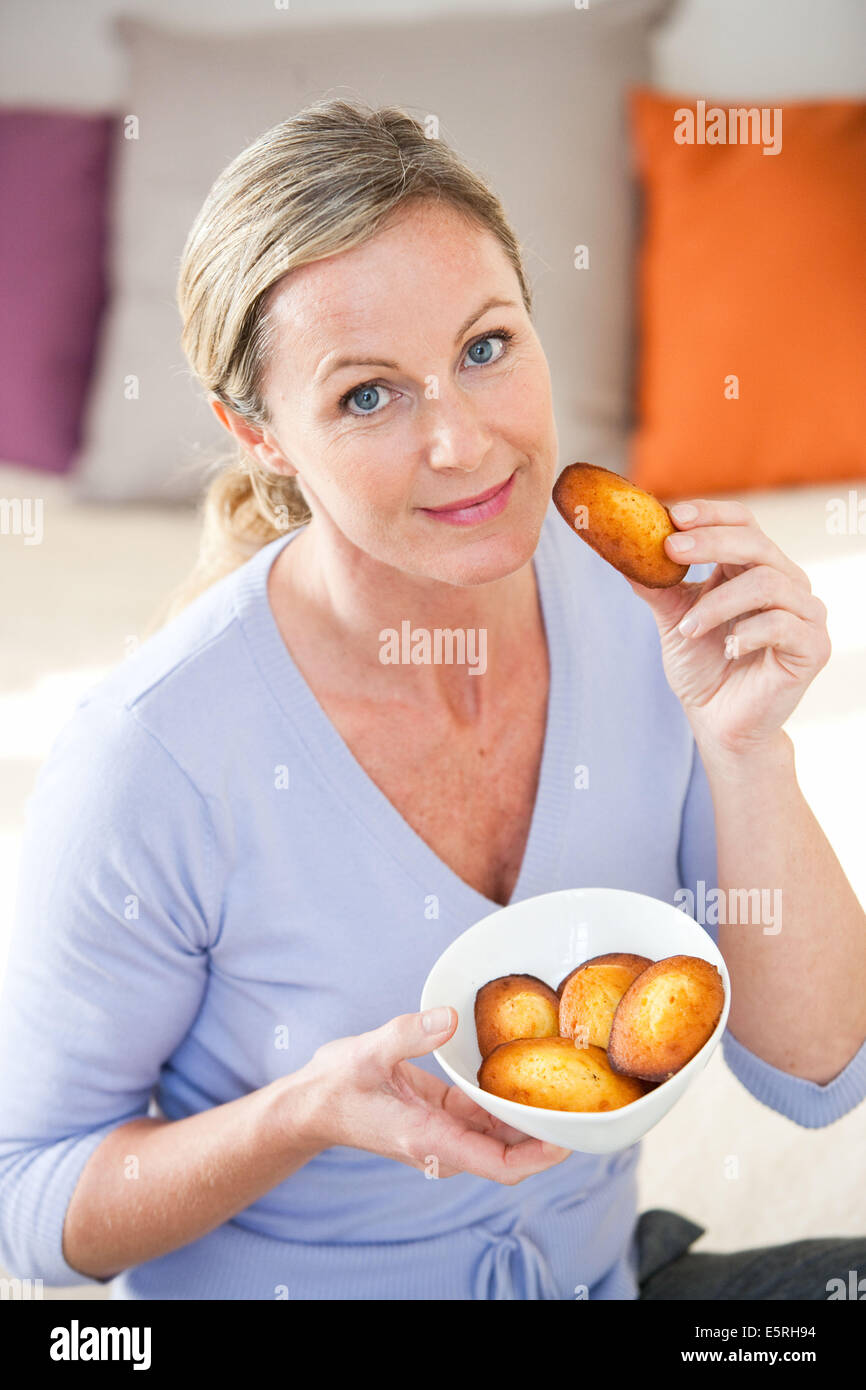 Woman eating cakes Stock Photo - Alamy