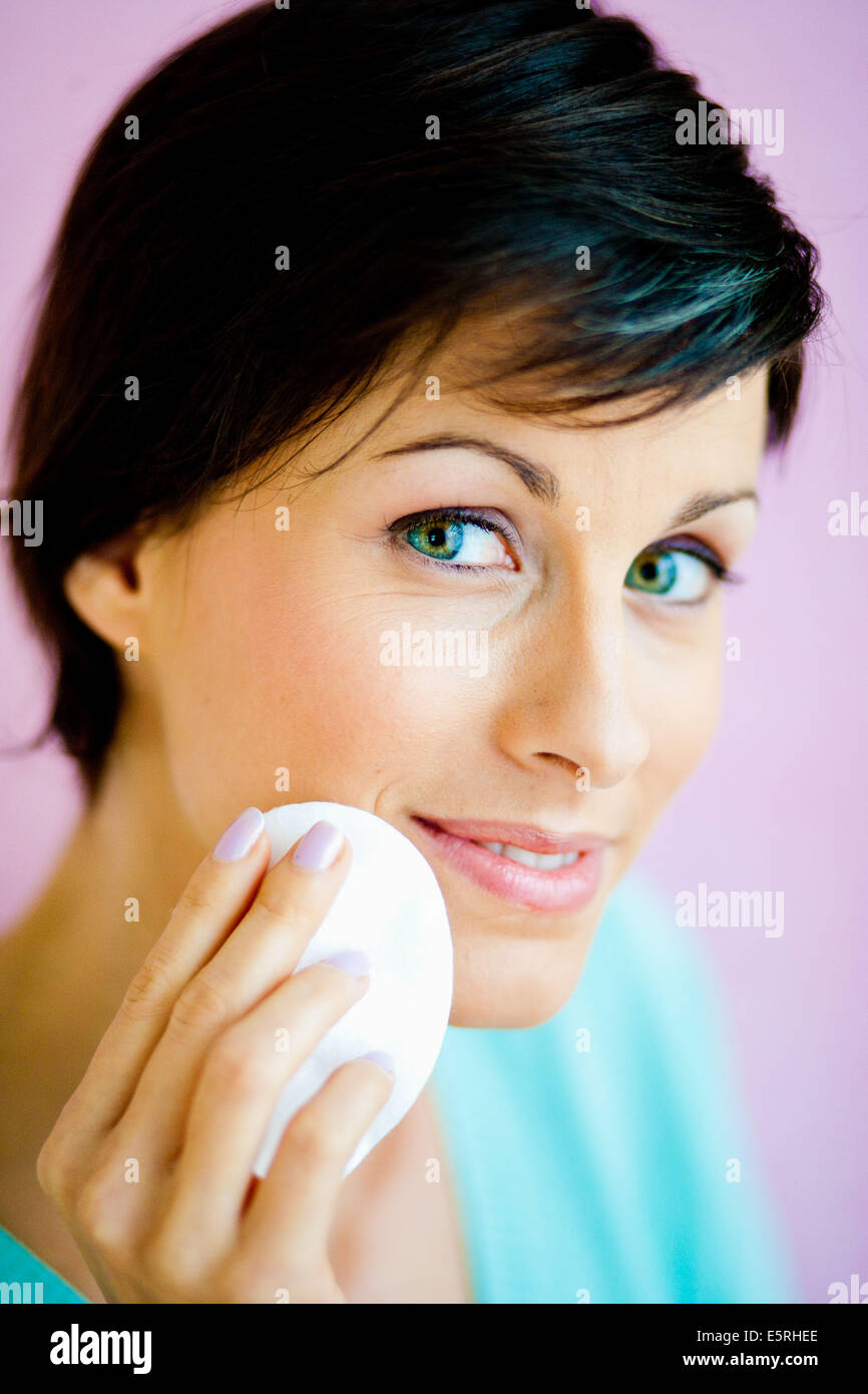 Woman removing make-up Stock Photo - Alamy