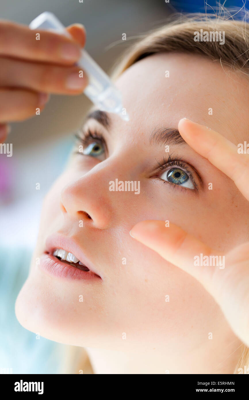 Woman applying eye-drops into her eye Stock Photo - Alamy