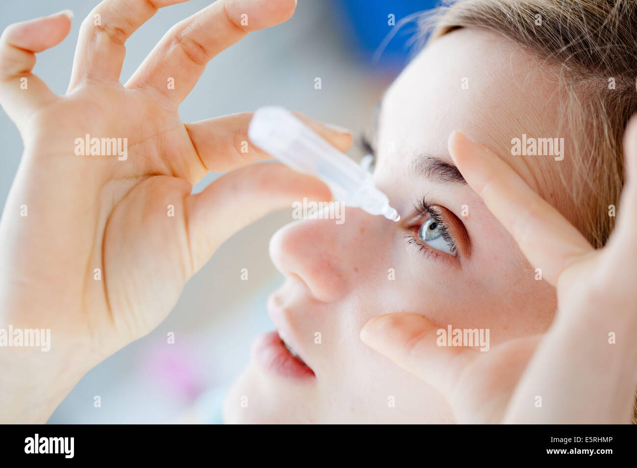 Woman applying eye-drops into her eye Stock Photo - Alamy