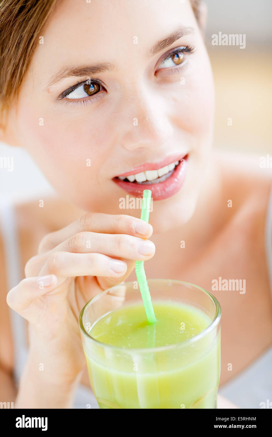 Woman drinking a smoothie (blended drink made from fruits Stock Photo ...