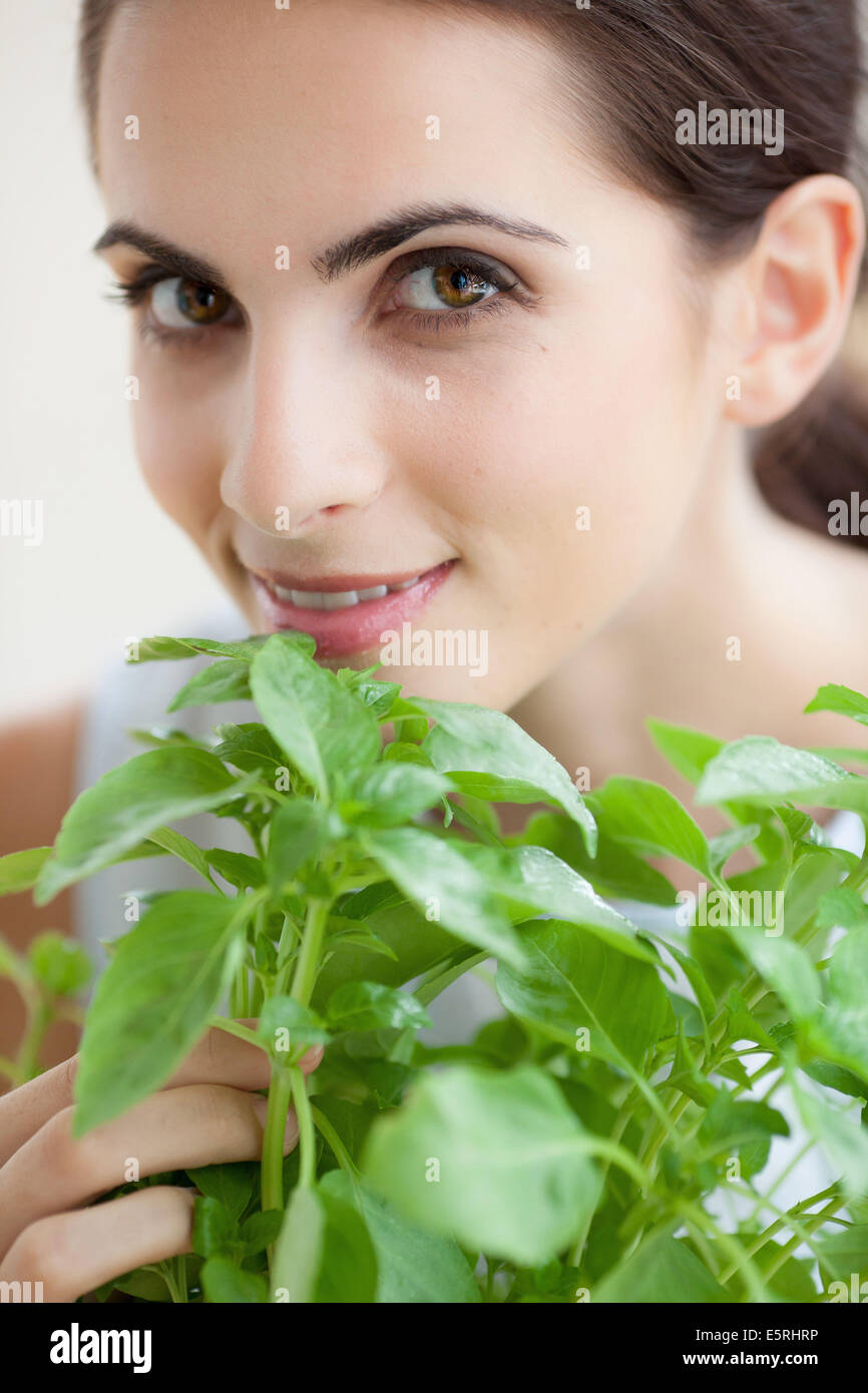 Woman smelling basil Stock Photo - Alamy