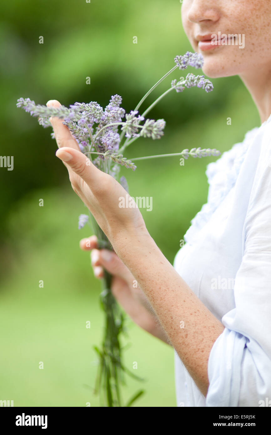 Woman smelling the scent of lavender Stock Photo - Alamy