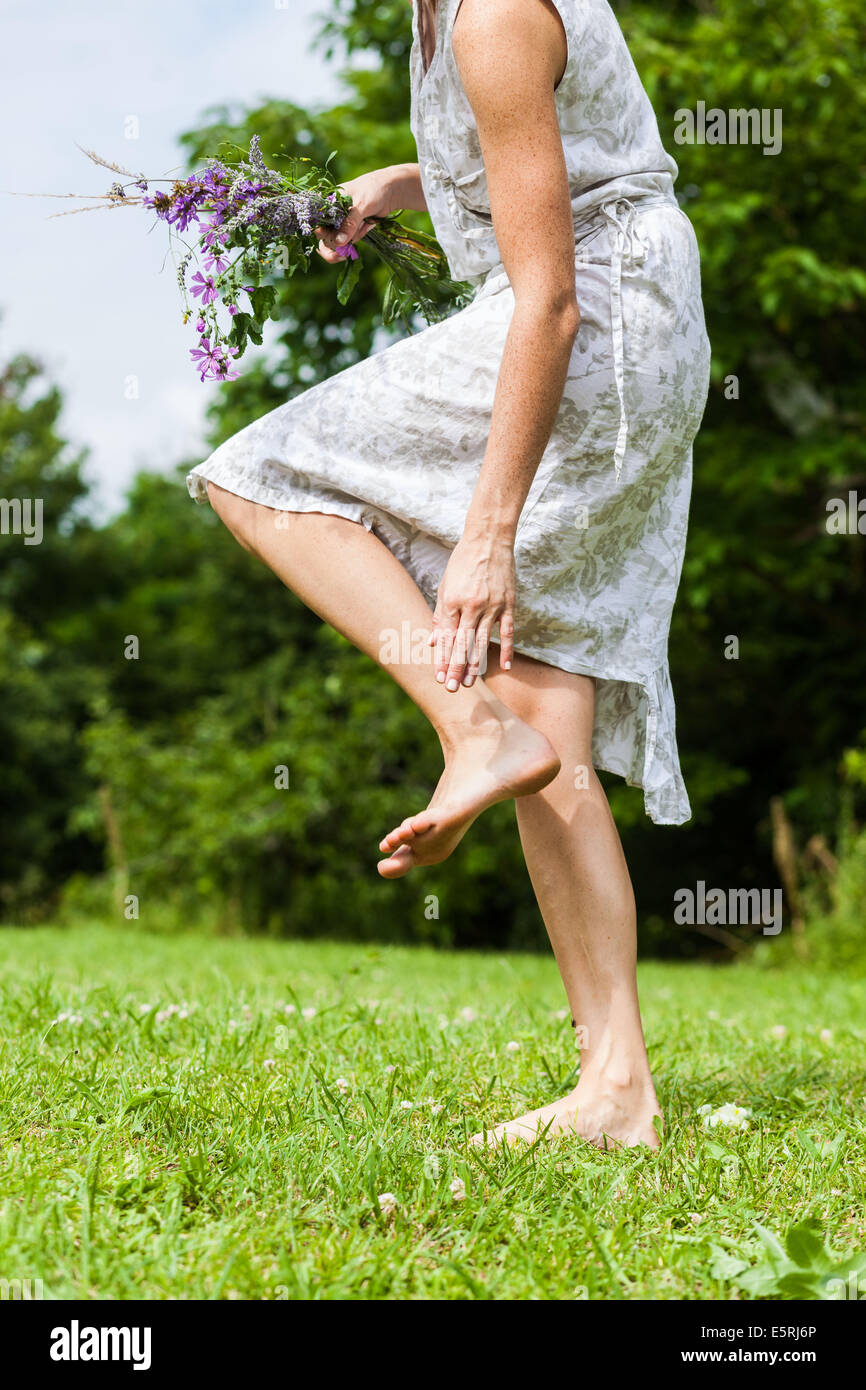 Woman itching her leg Stock Photo - Alamy