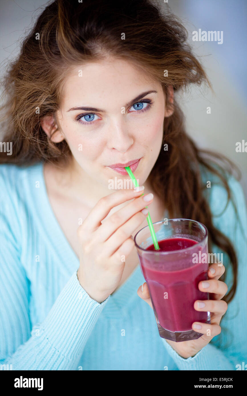 Woman drinking smoothie Stock Photo - Alamy