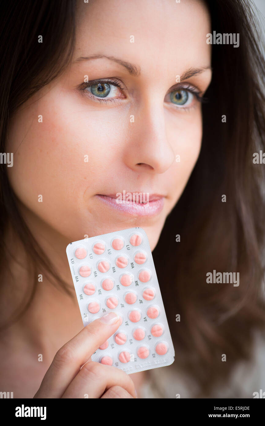 Woman holding tablets Stock Photo - Alamy