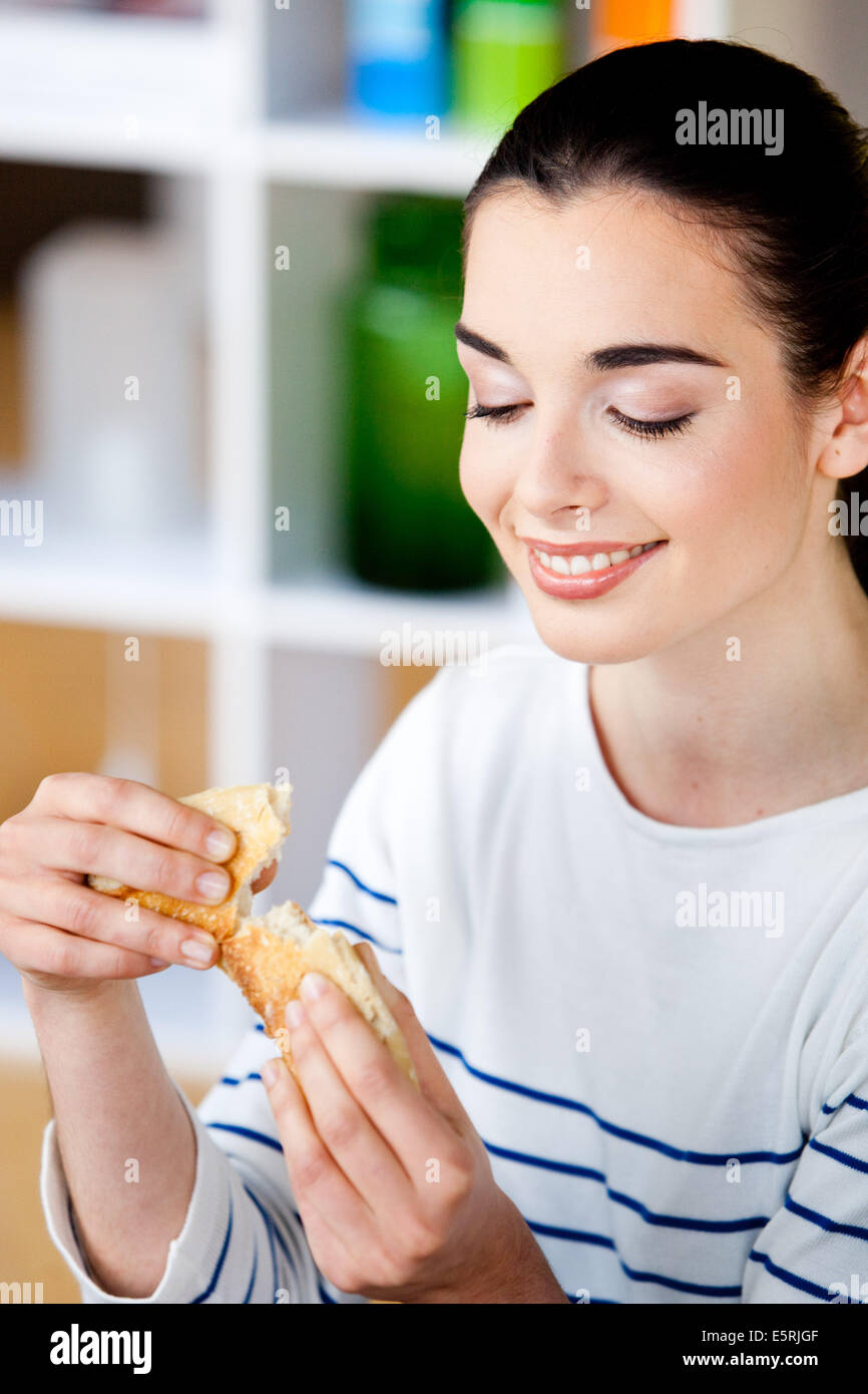 Woman eating bread Stock Photo - Alamy
