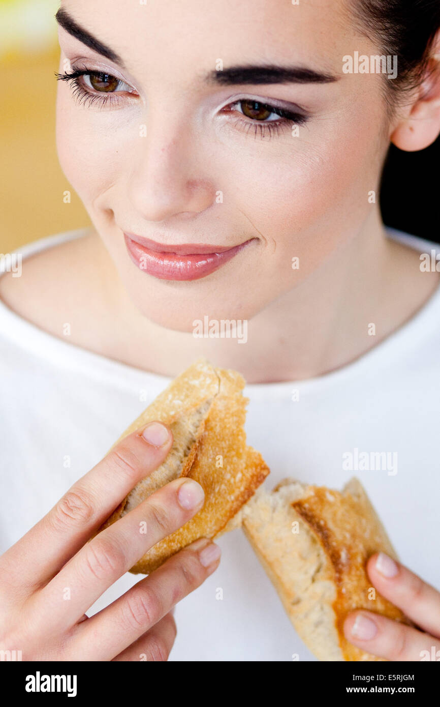 Woman eating bread Stock Photo - Alamy