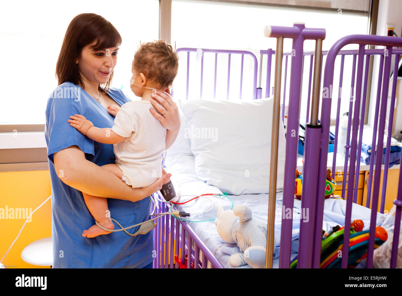 Nurse and baby in the pediatric intensive care unit and intensive care ...
