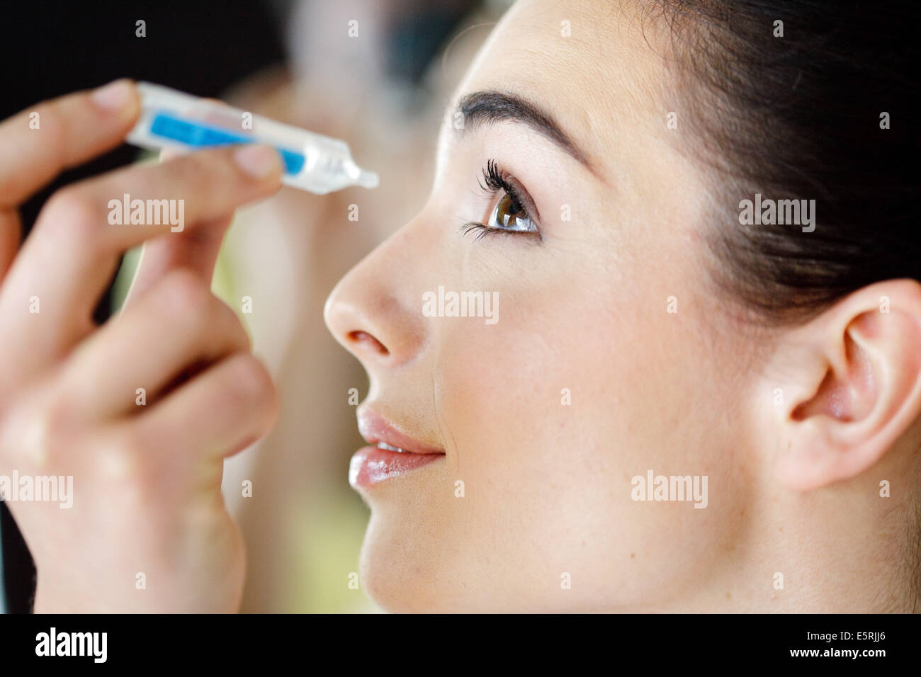 Woman applying eye-drops into her eye Stock Photo - Alamy