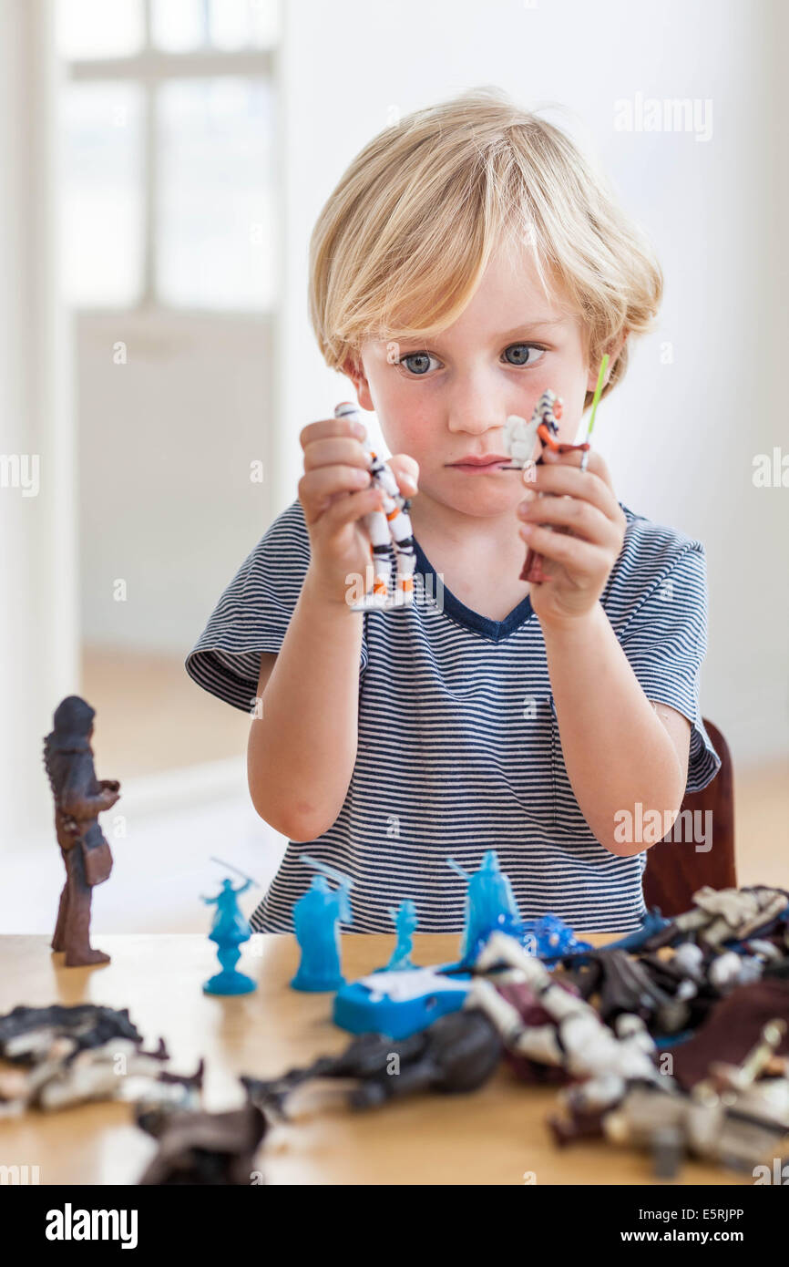 5-year-old boy playing with figurines Stock Photo - Alamy