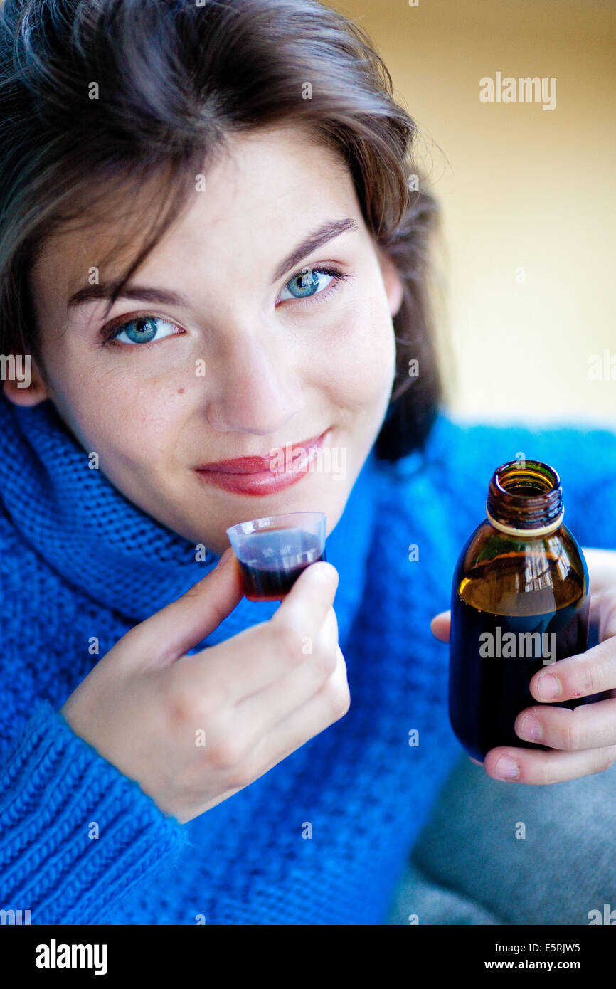Woman taking syrup Stock Photo - Alamy