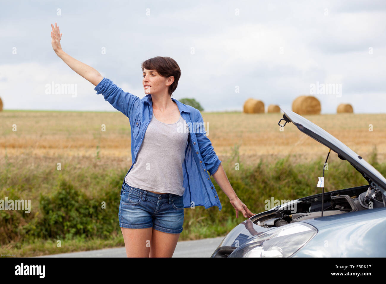 Woman with car trouble Stock Photo - Alamy