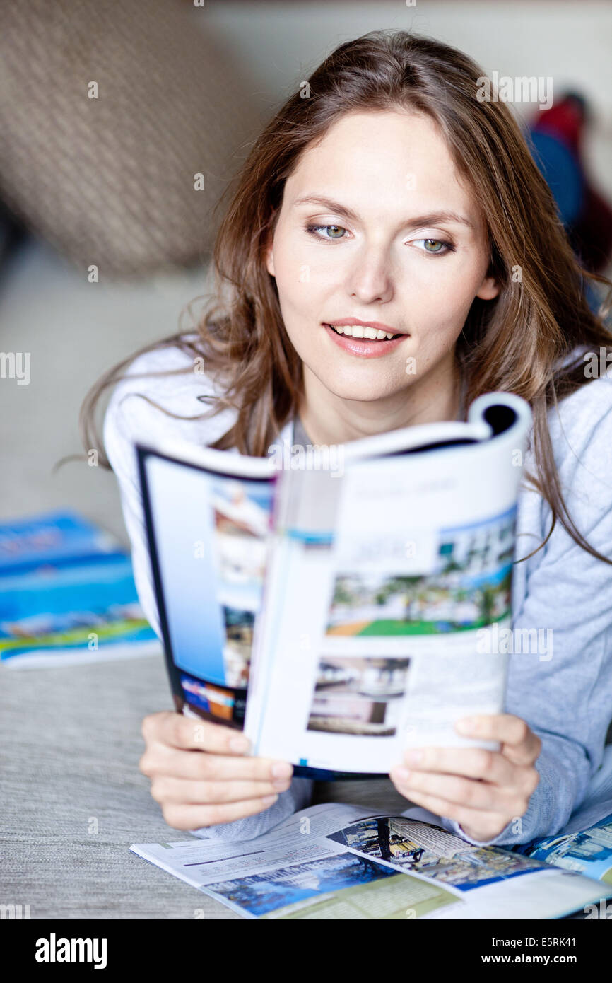 Woman reading magazine Stock Photo - Alamy