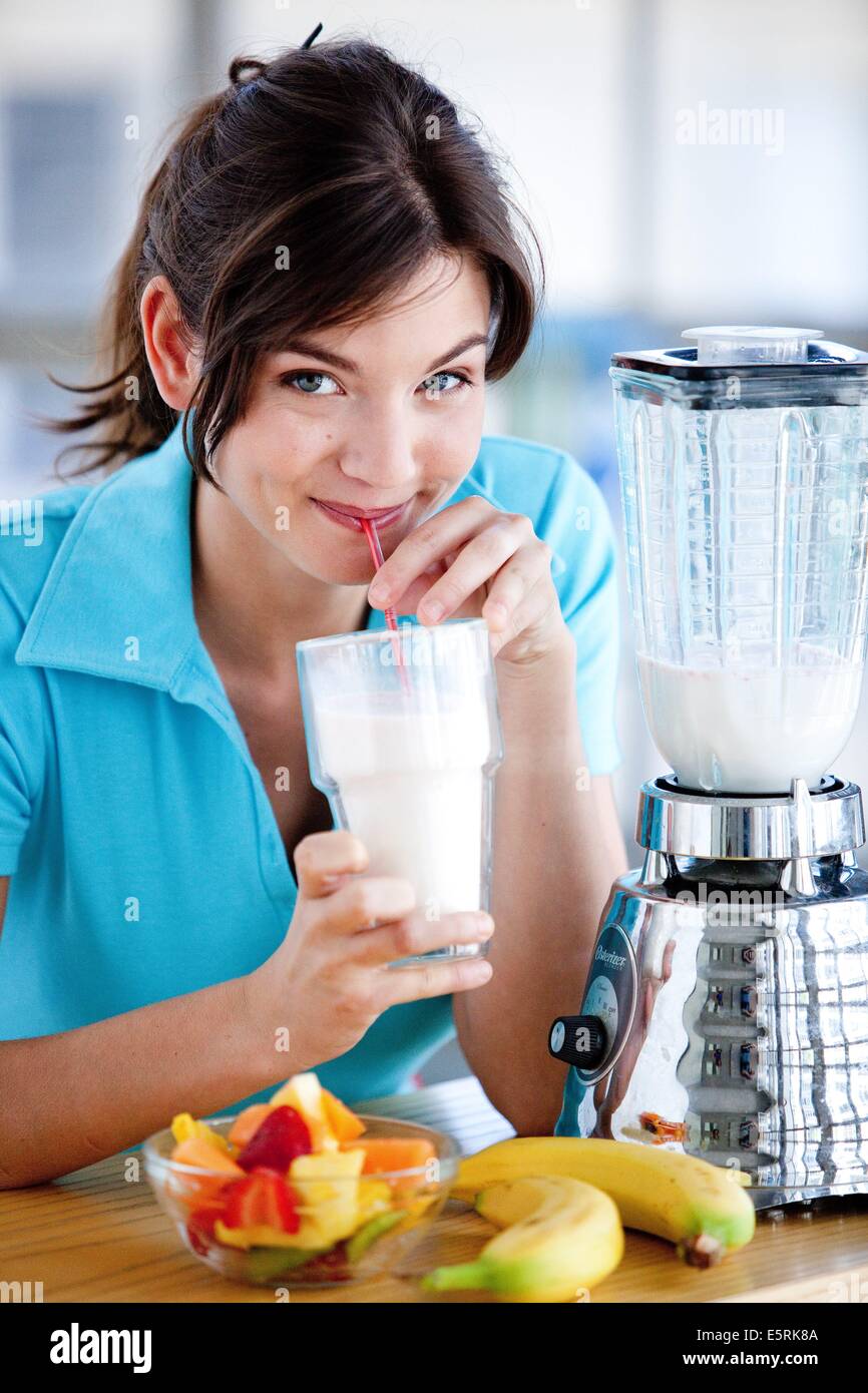 Woman drinking fruit smoothie Stock Photo - Alamy