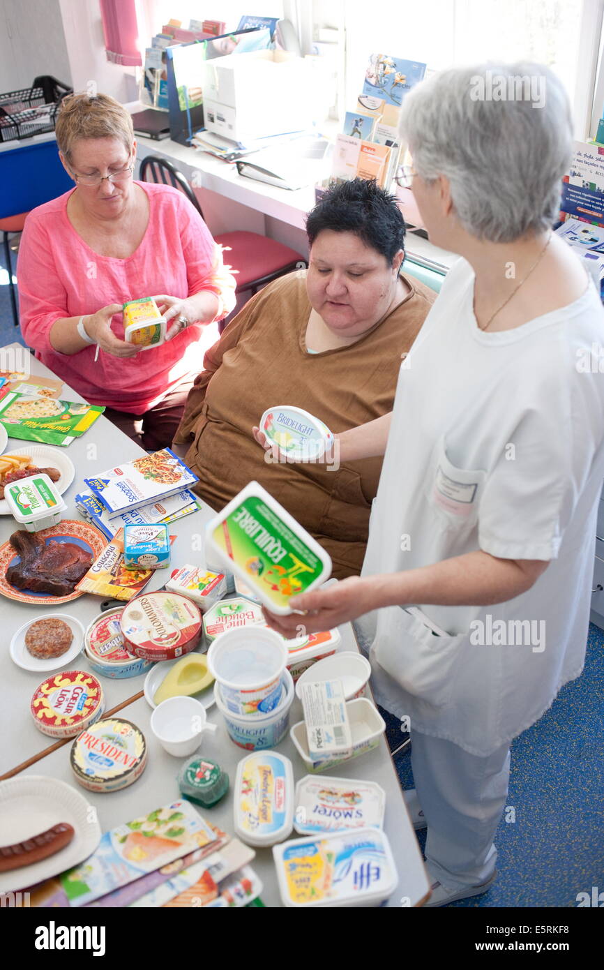 A nurse is holding a nutritional education workshop for obese patients ...