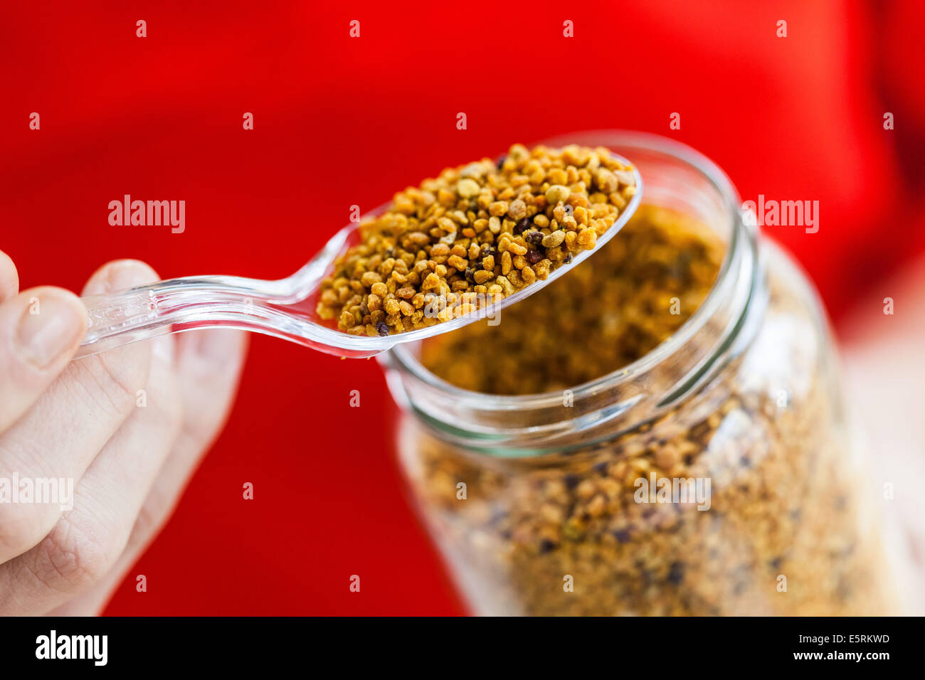 Woman eating pollen Stock Photo - Alamy