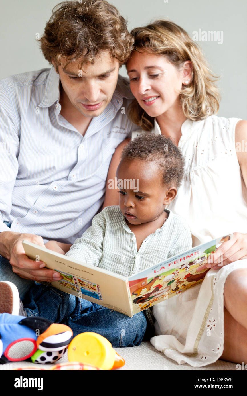 Adopted boy with his parents Stock Photo - Alamy