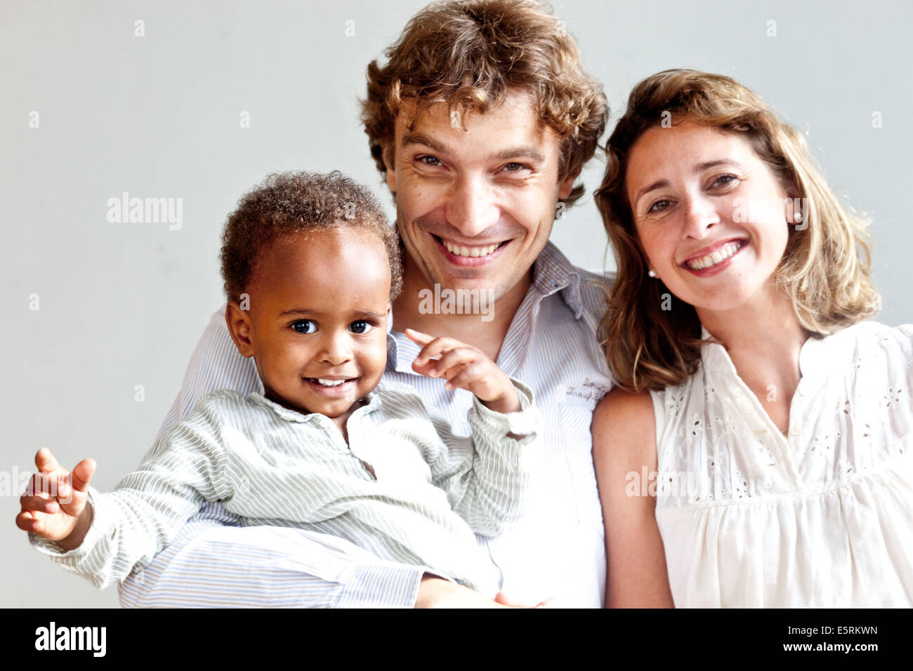Adopted boy with his parents Stock Photo - Alamy