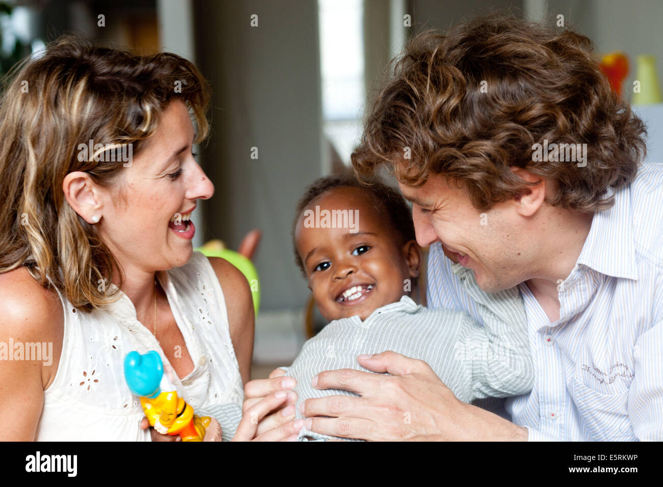 Adopted boy with his parents Stock Photo - Alamy