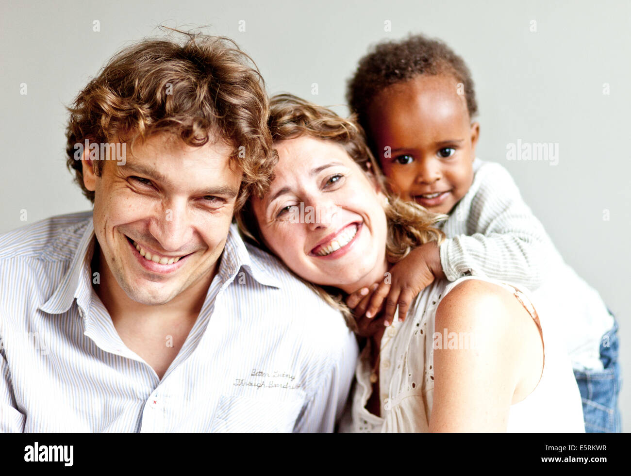 Adopted boy with his parents Stock Photo - Alamy