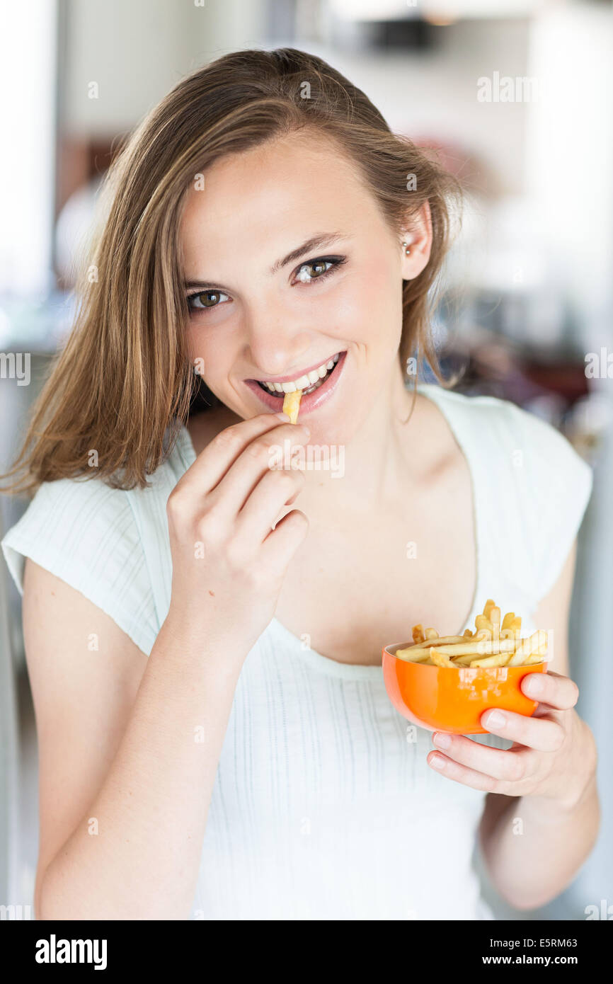 Woman french fries looking at camera hi-res stock photography and ...