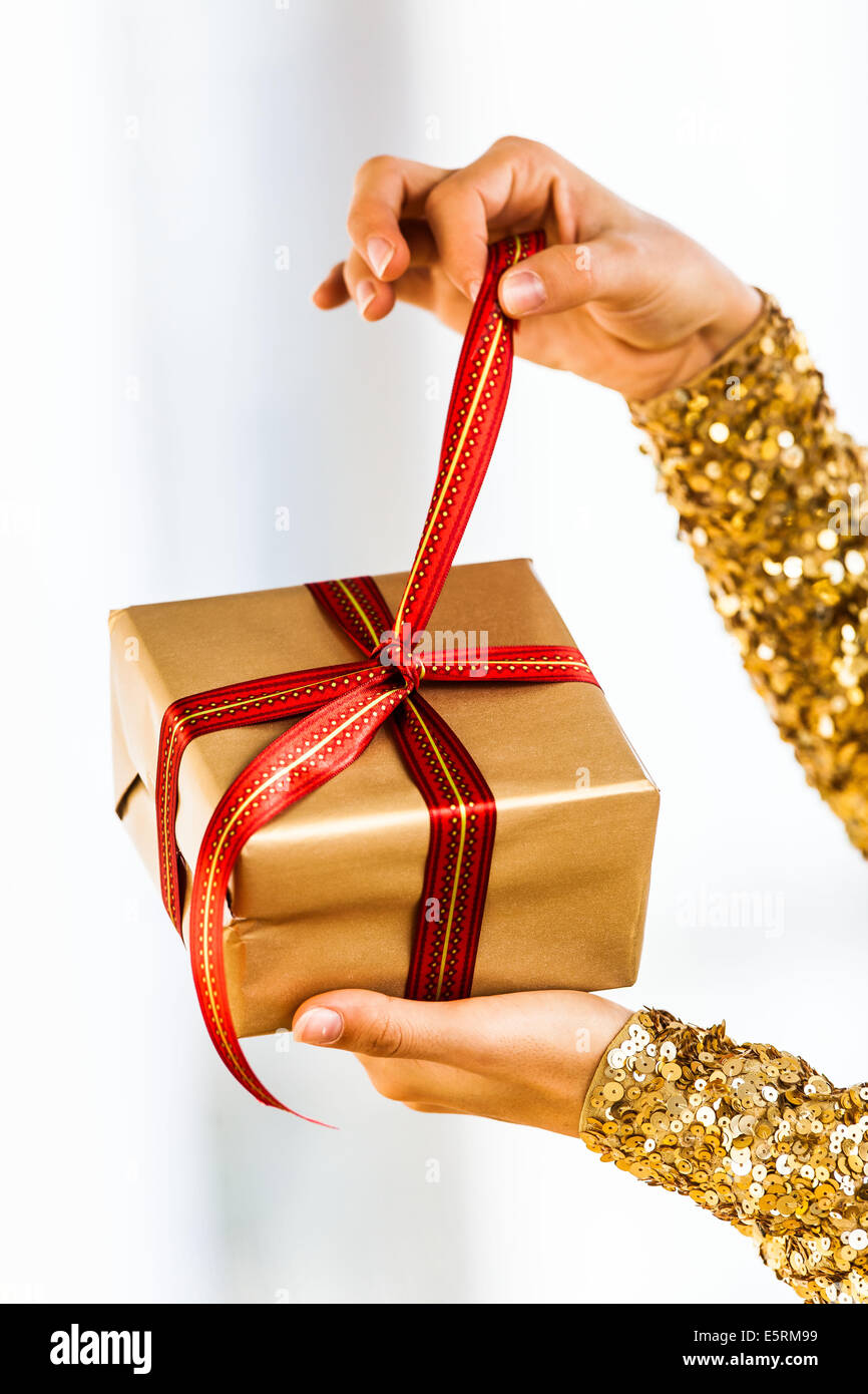 Woman opening a present Stock Photo - Alamy
