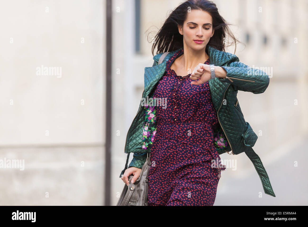 Woman looking at her watch Stock Photo - Alamy