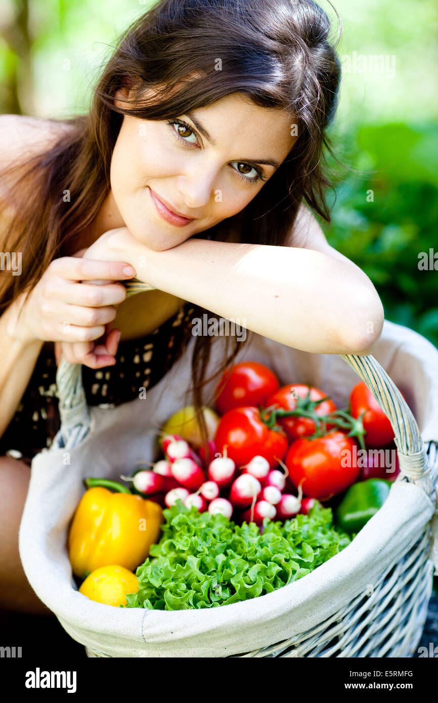 Woman with vegetables basket Stock Photo - Alamy