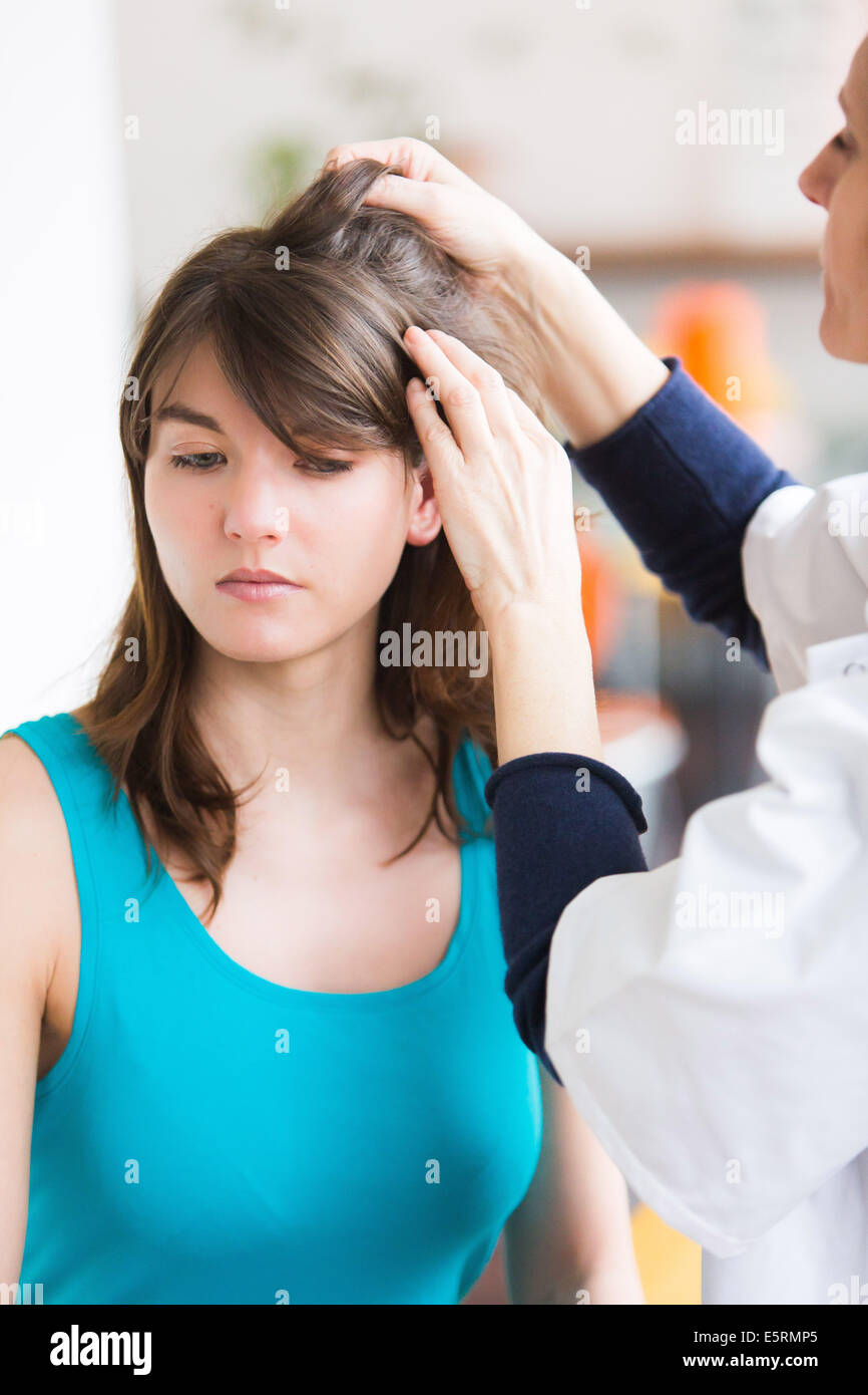 Doctor examining the scalp of a woman Stock Photo - Alamy