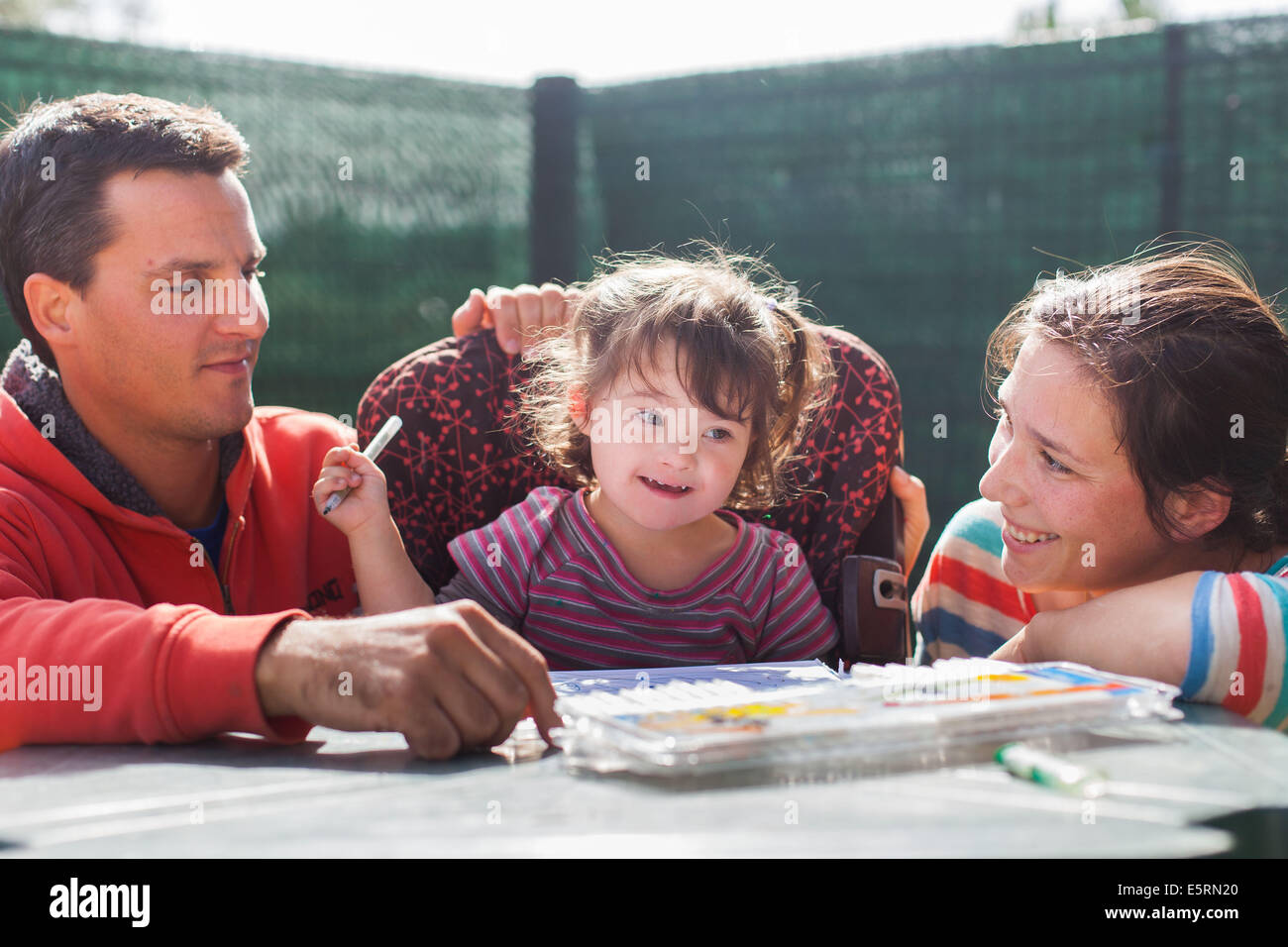2 and a half year old girl with Down's syndrome with her parents Stock ...
