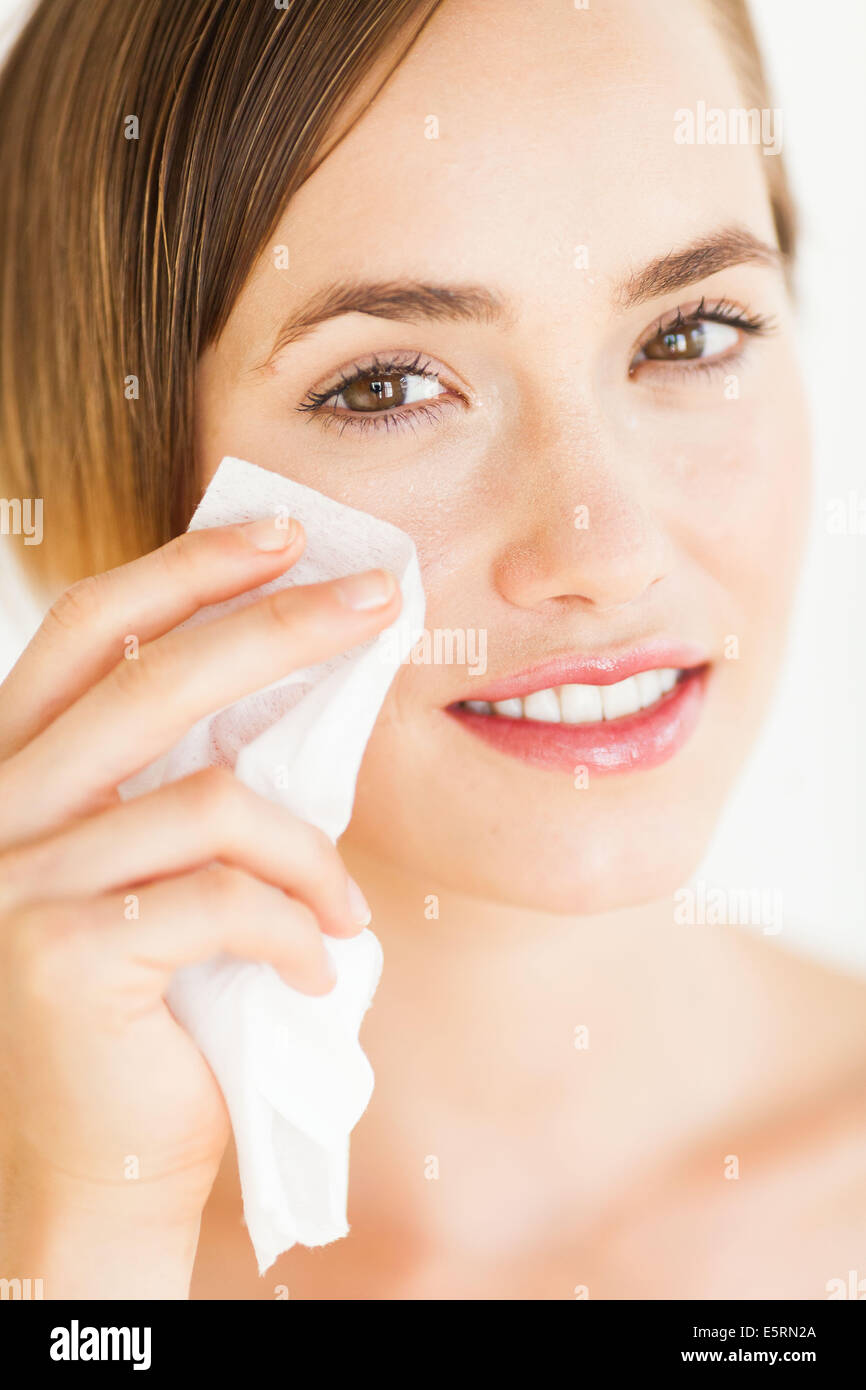 Woman using a make-up remover Stock Photo - Alamy