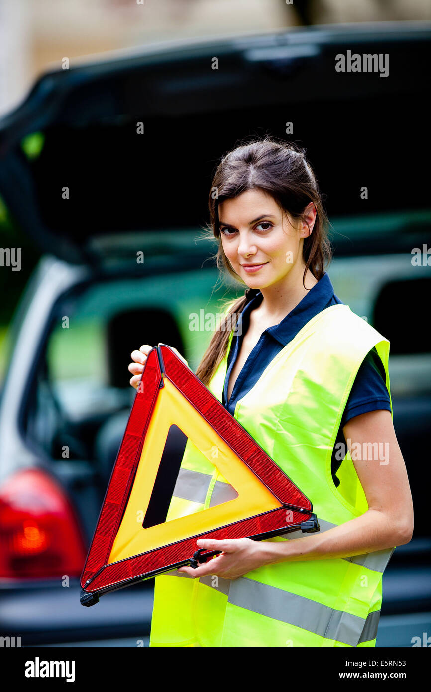 Road safety triangle and safety vest Stock Photo - Alamy
