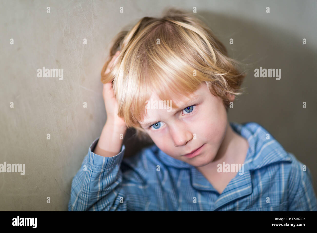 Boy scratching his head Stock Photo - Alamy