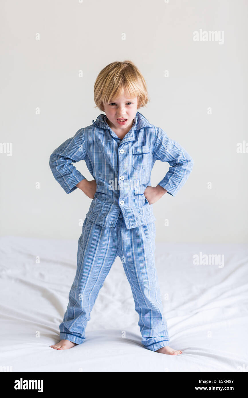 Angry boy standing on bed Stock Photo - Alamy