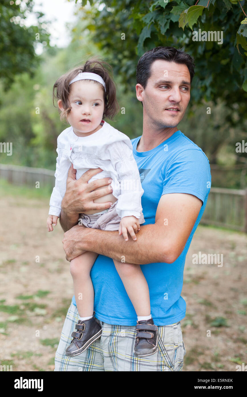 2 and a half year old girl with Down's syndrome with her father Stock ...