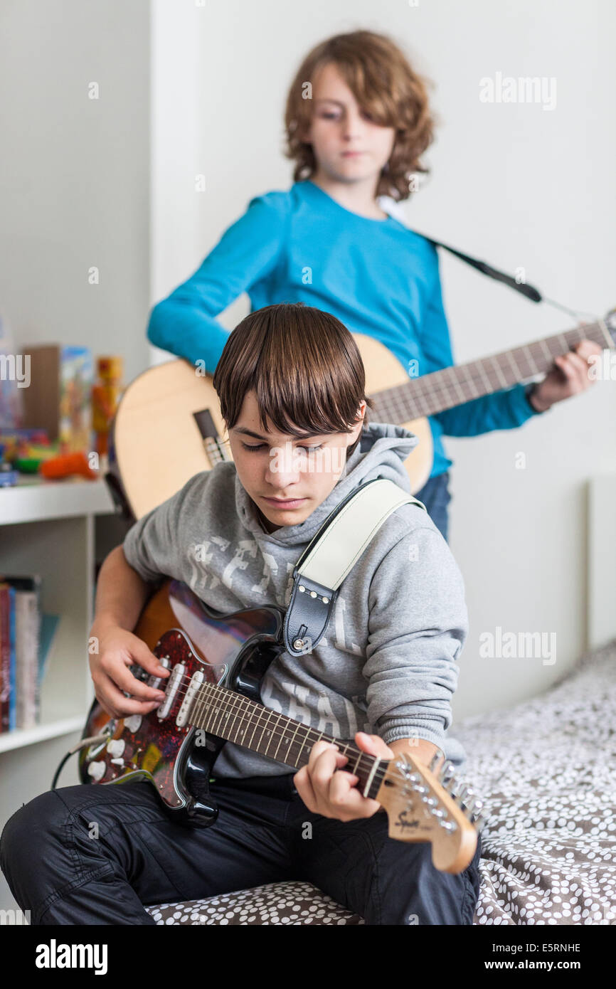 Teenage boys playing guitar Stock Photo - Alamy