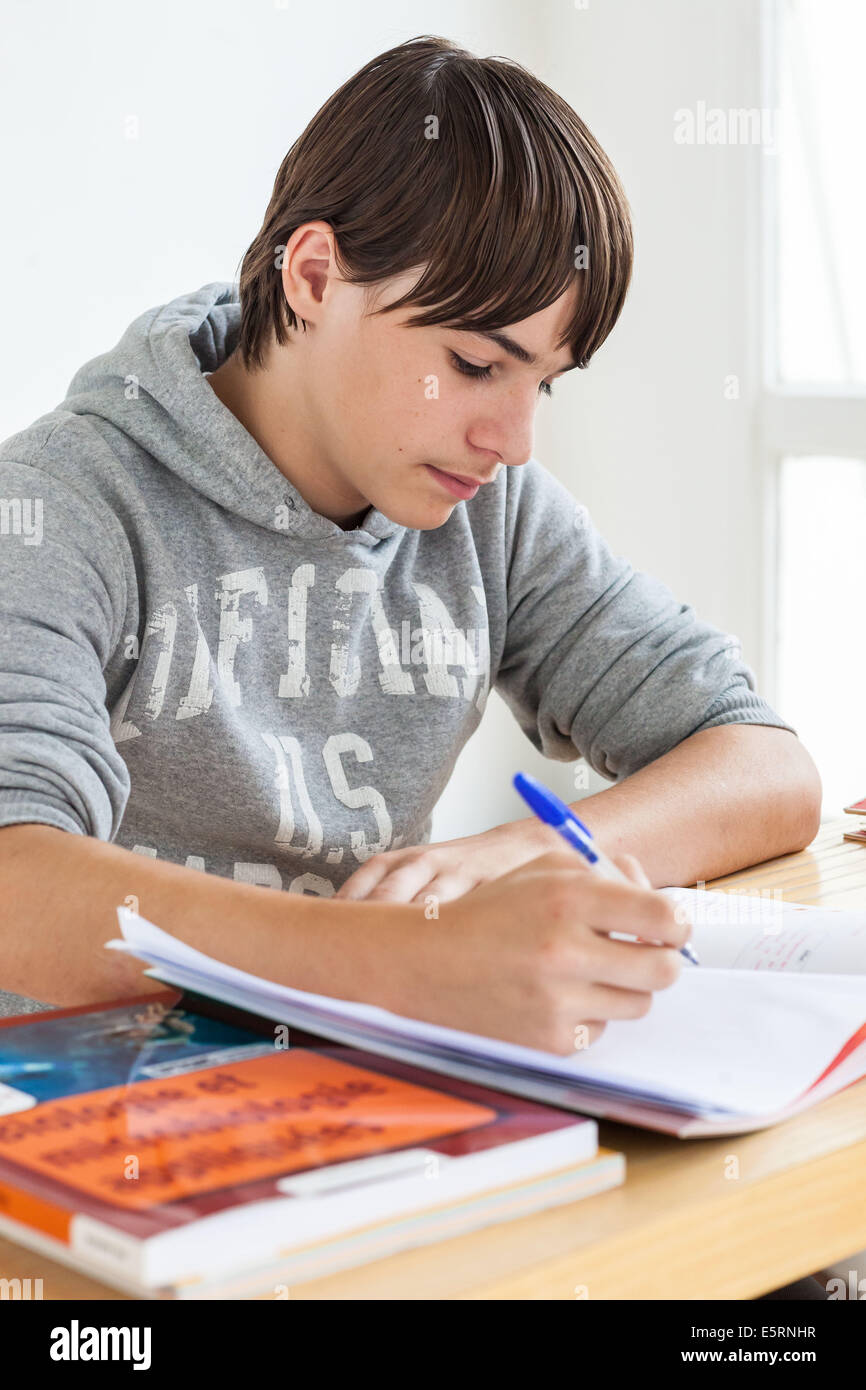 Teenage boy doing homework Stock Photo - Alamy