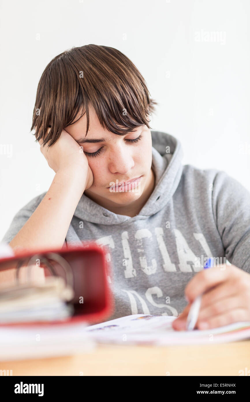 Teenage boy doing homework Stock Photo - Alamy